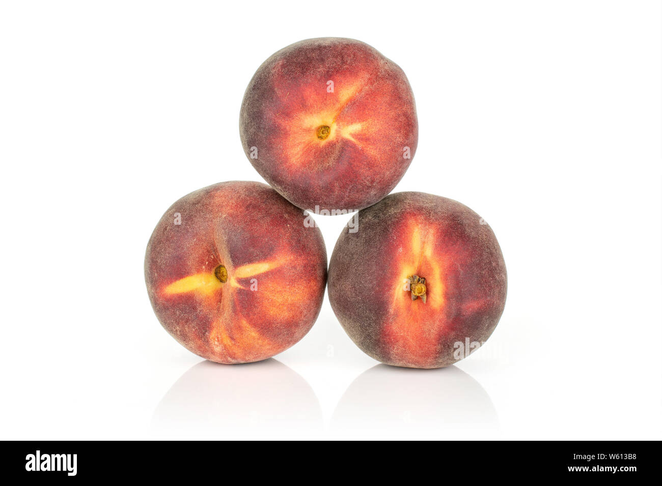 Group of three whole fresh red peach arranged in a pyramid isolated on ...