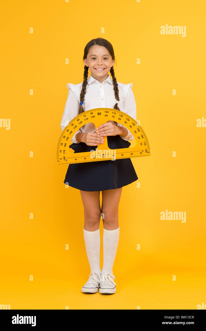 Towards knowledge. happy small school girl study geometry. student use ...