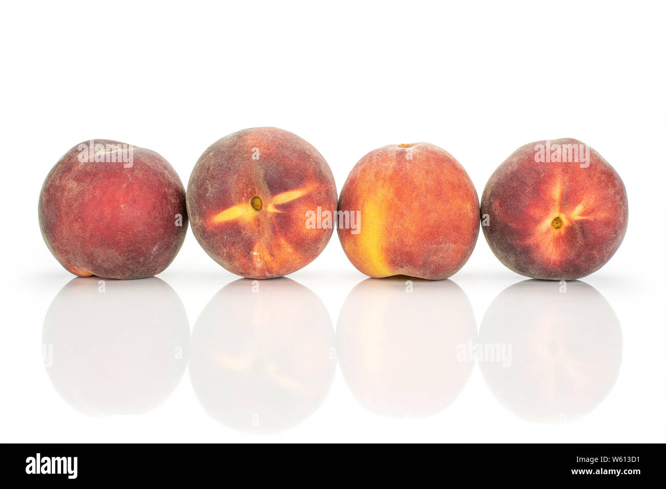 Group of four whole fresh red peach in a row isolated on white ...