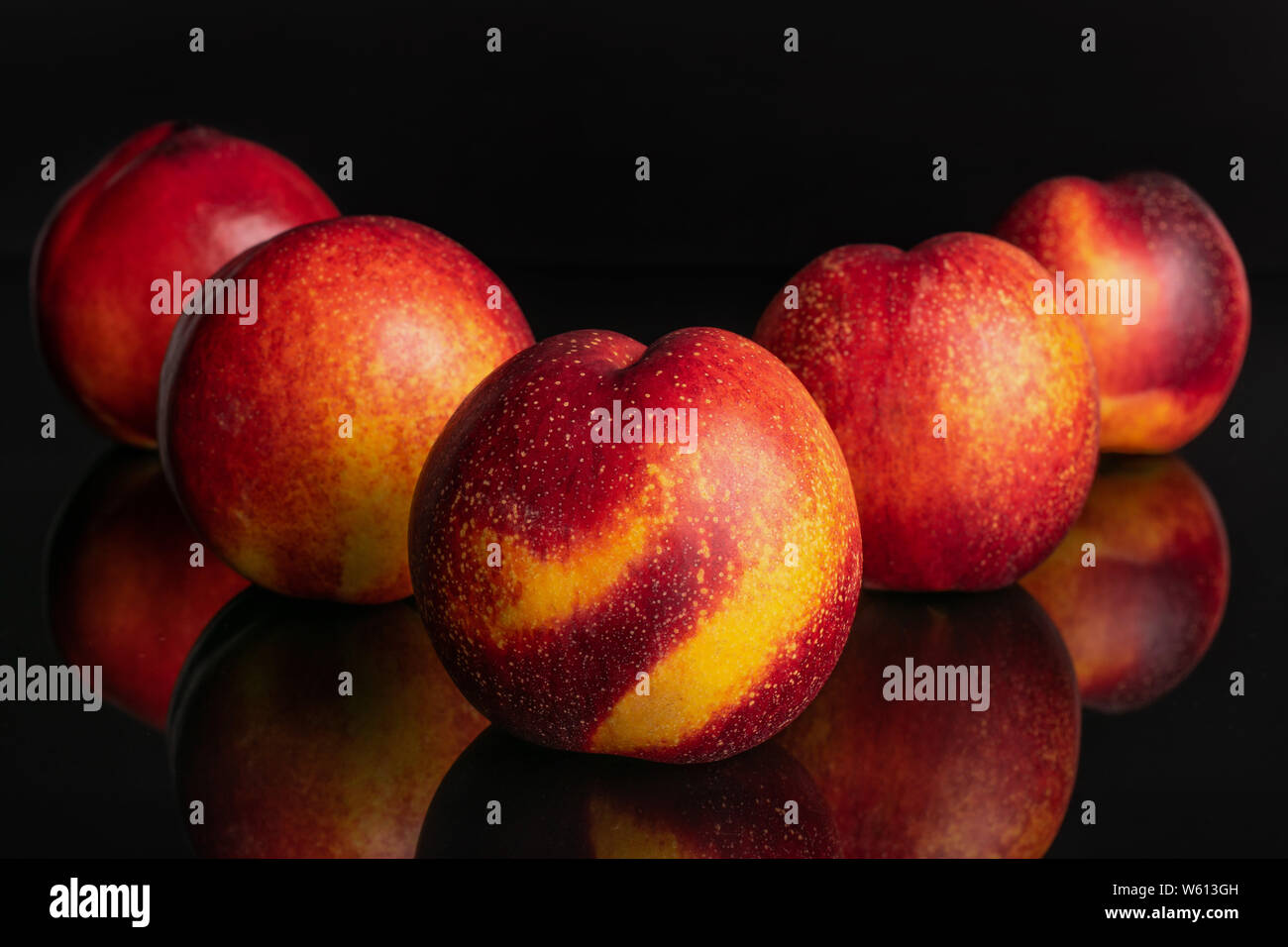 Group of five whole fresh red nectarine one is in the front and the ...