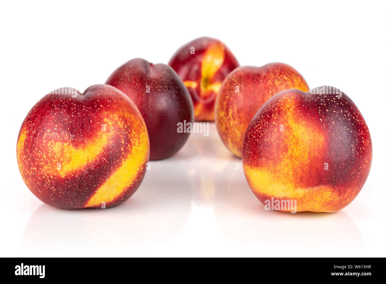 Group of five whole fresh red nectarine layered symmetrically isolated ...