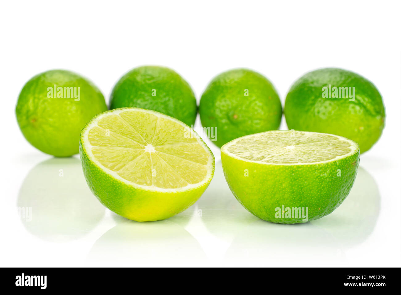Group of four whole two halves of fresh green lime isolated on white ...