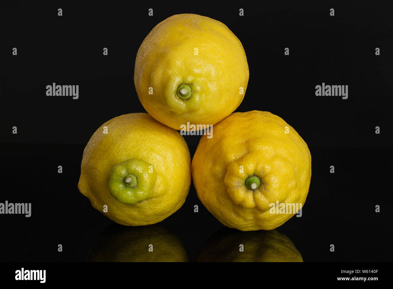 Group of three whole fresh yellow lemon arranged into a pyramid ...