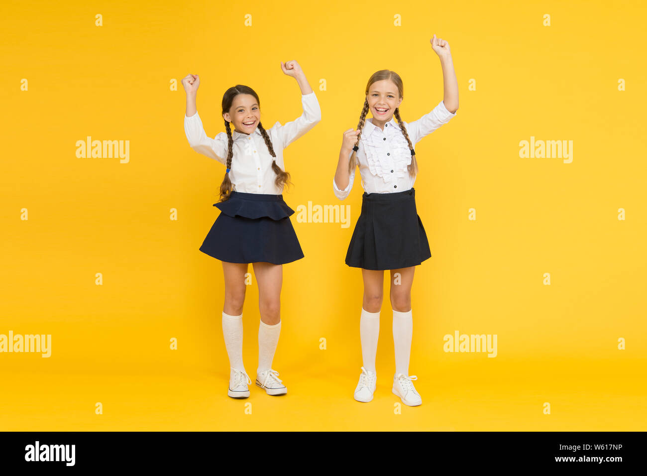 Together we are winners. Little schoolchildren making winner gestures ...