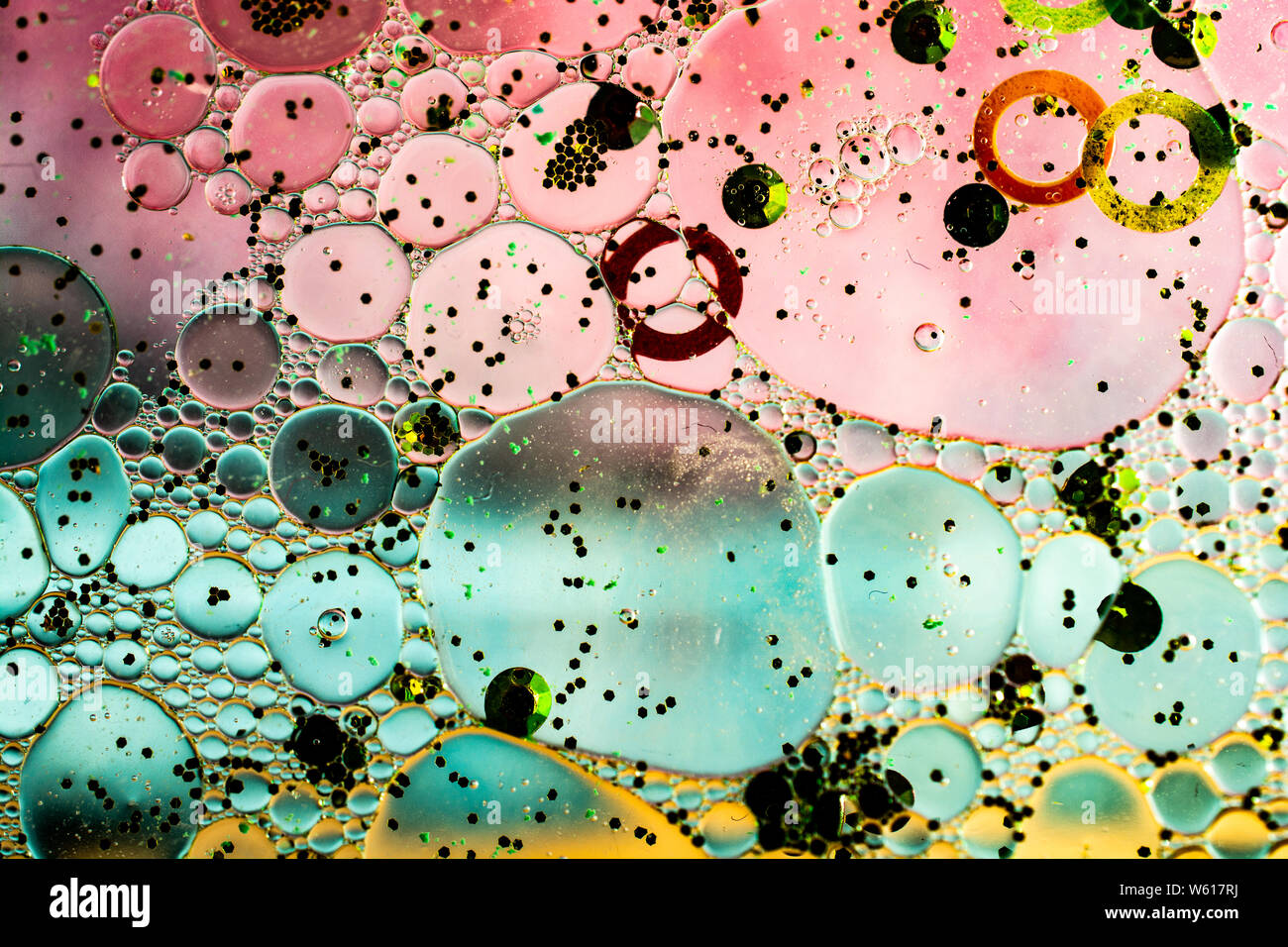 Oil bubbles inside water base form patterns Stock Photo - Alamy