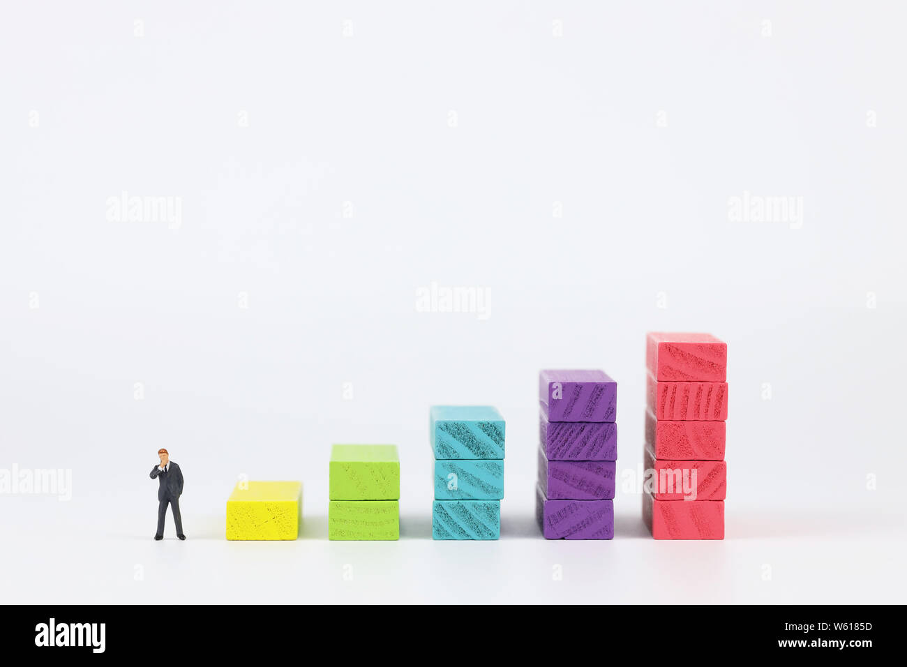 businessman thinking of something when he see company graph (stacking ...