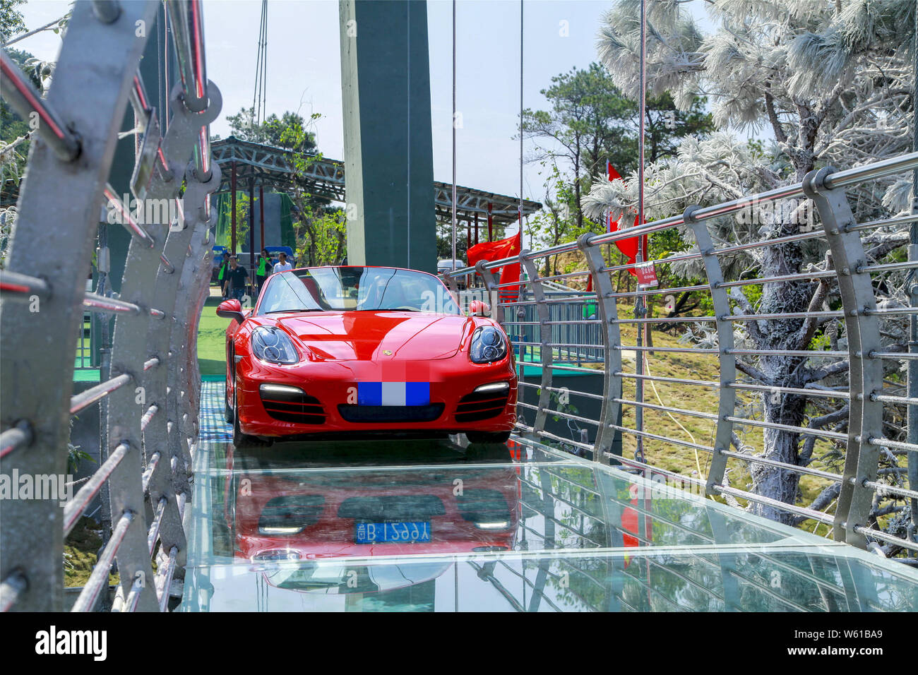 A Porsche sports car drives across Guangdong's longest glass-bottomed ...