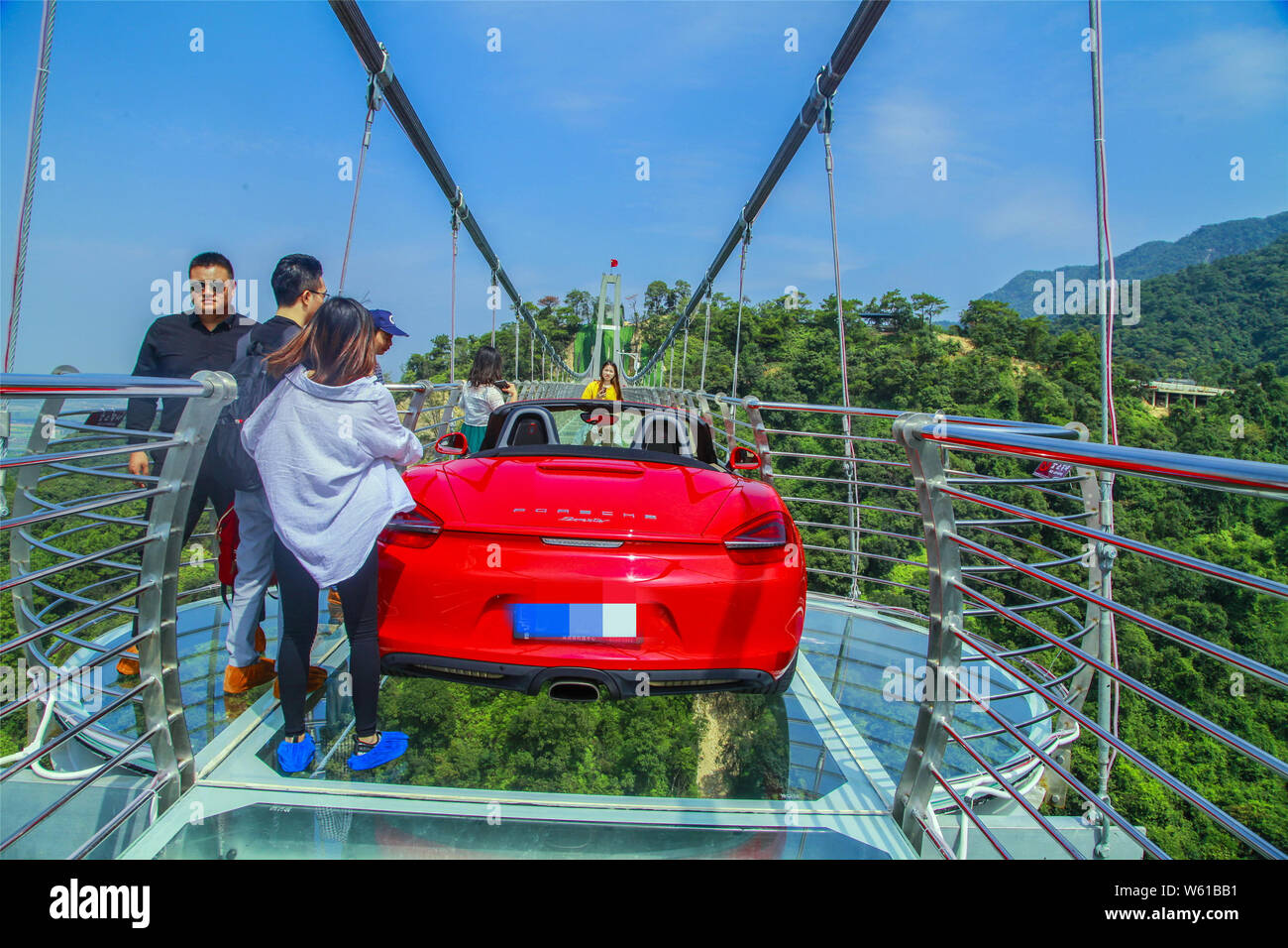 A Porsche sports car is parked on Guangdong's longest glass-bottomed ...