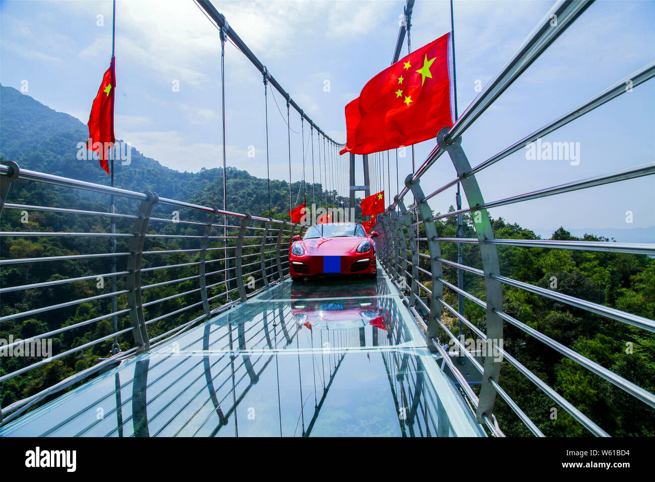 A Porsche sports car drives across Guangdong's longest glass-bottomed ...