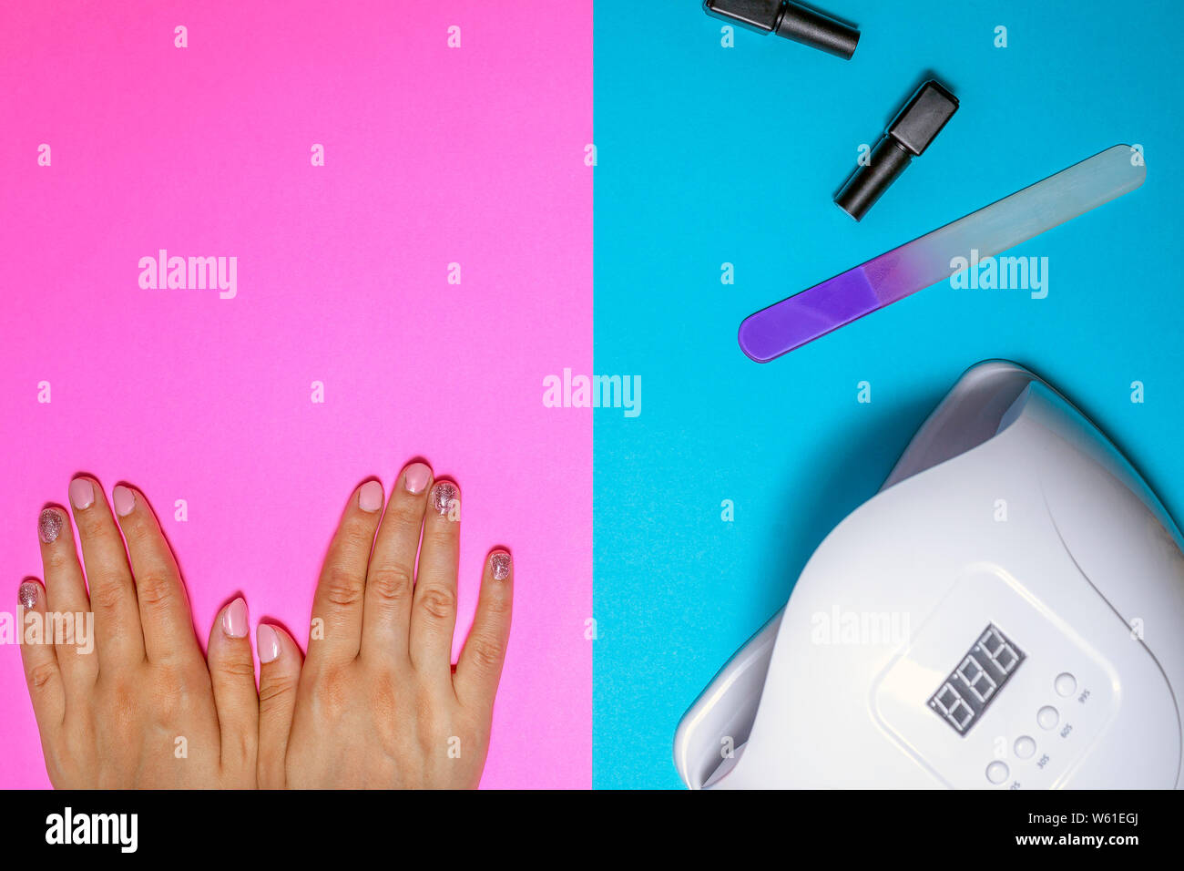 A young woman manicured hands after procedure. Pretty girl using ...