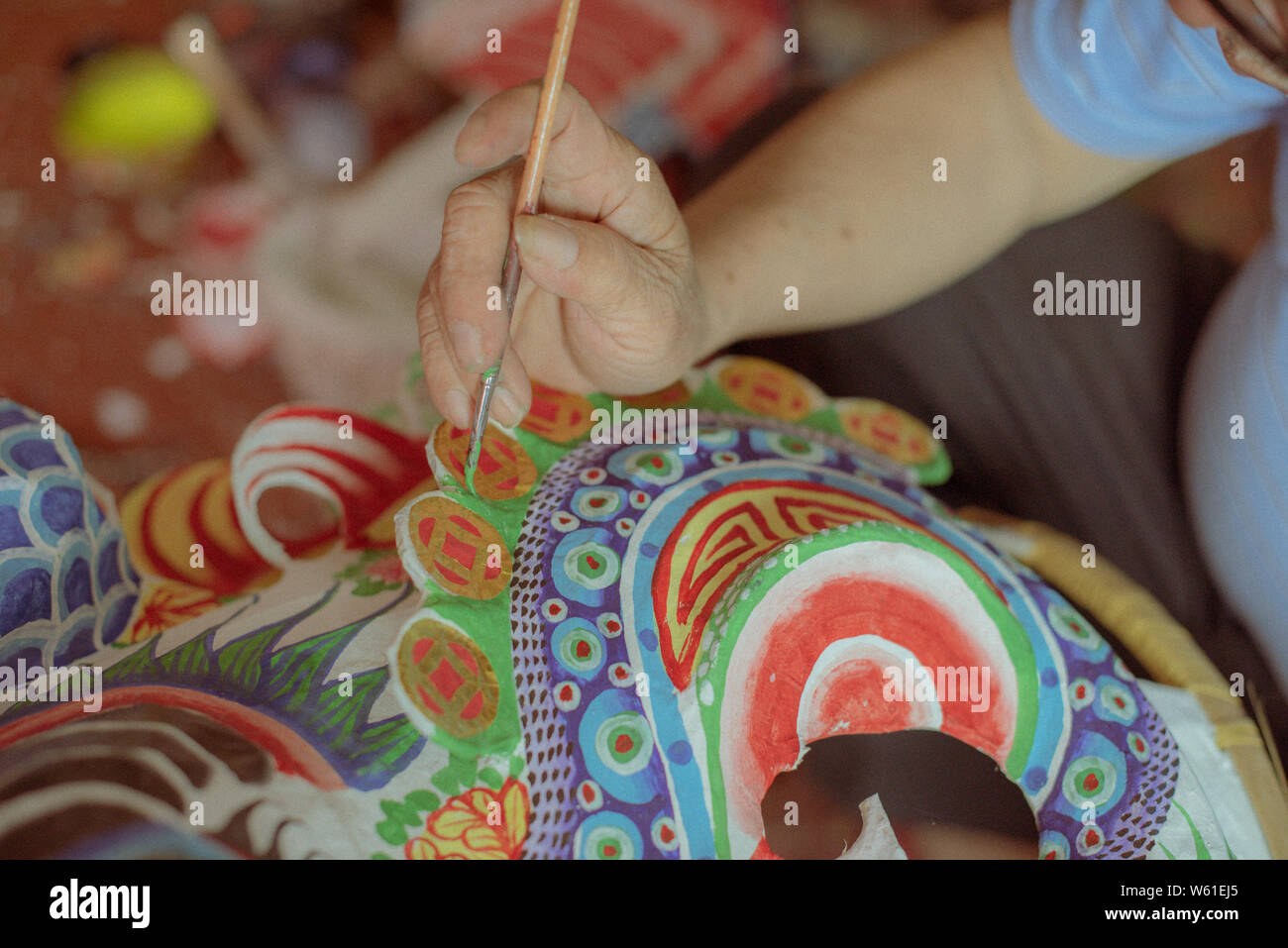 A craftsman makes a head of Qilin, to perform Qilin Dance at a workshop ...
