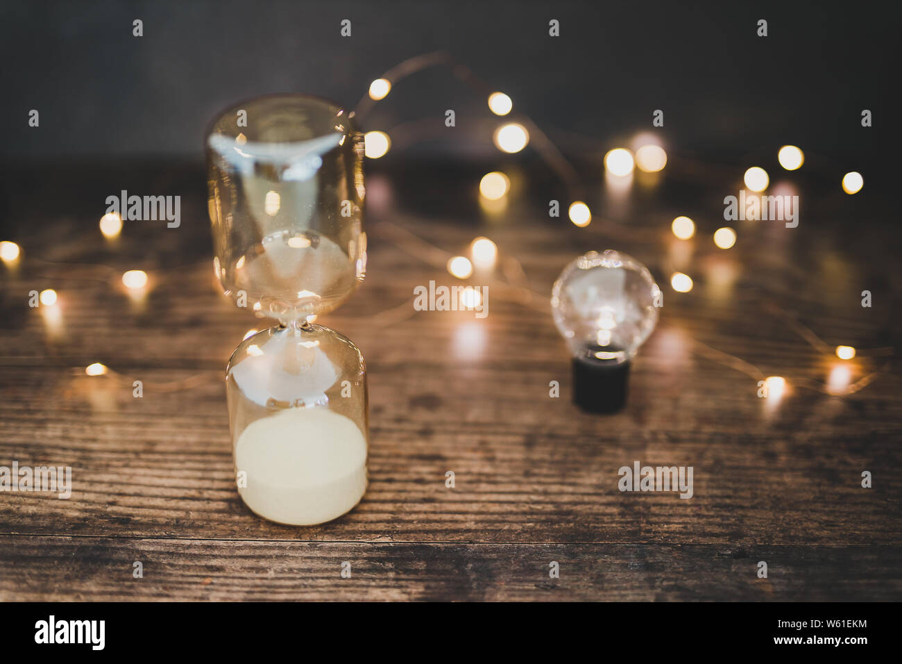 time for new ideas conceptual image with hourglass and lightbulb ...