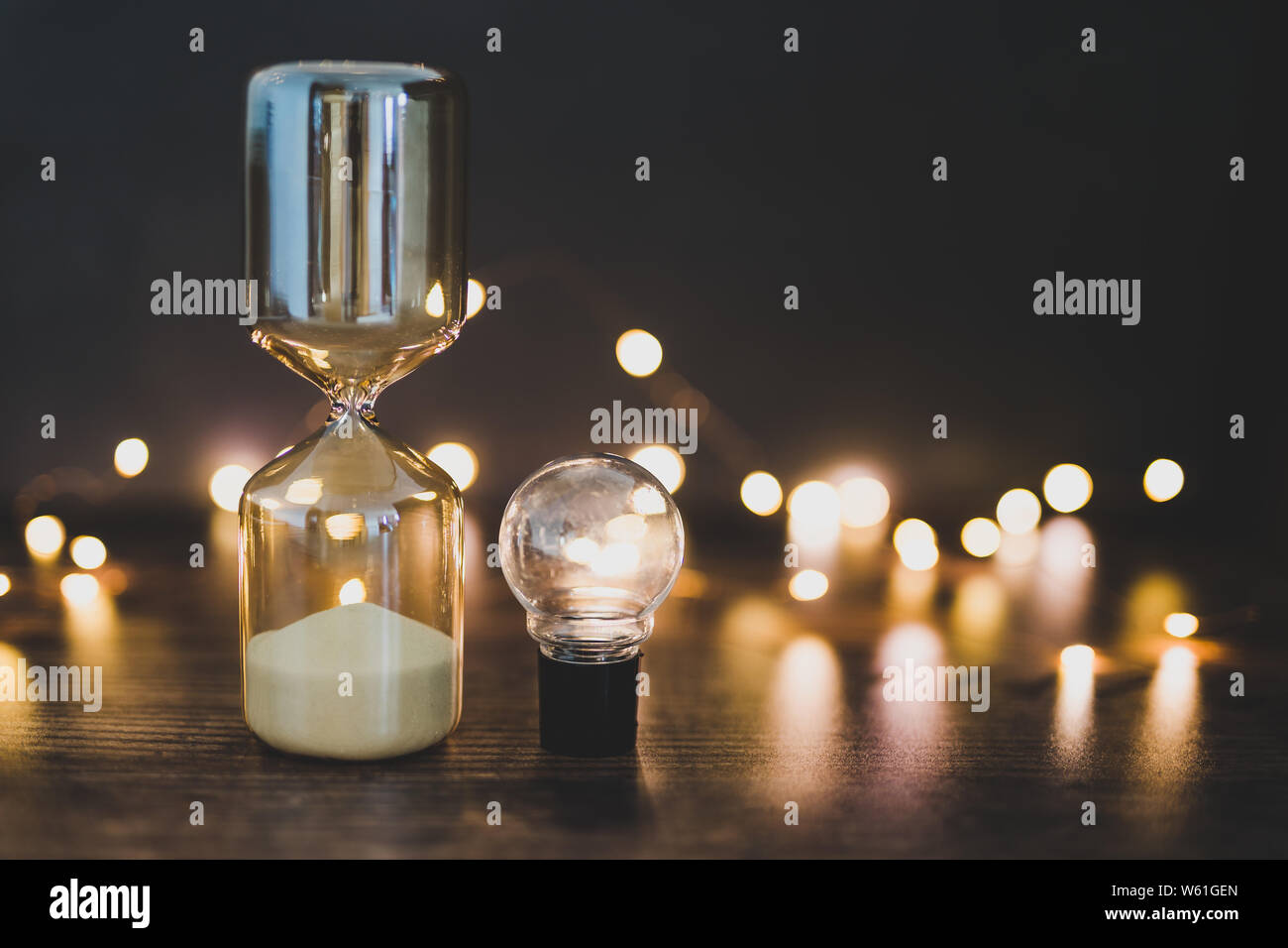 time for new ideas conceptual image with hourglass and lightbulb ...