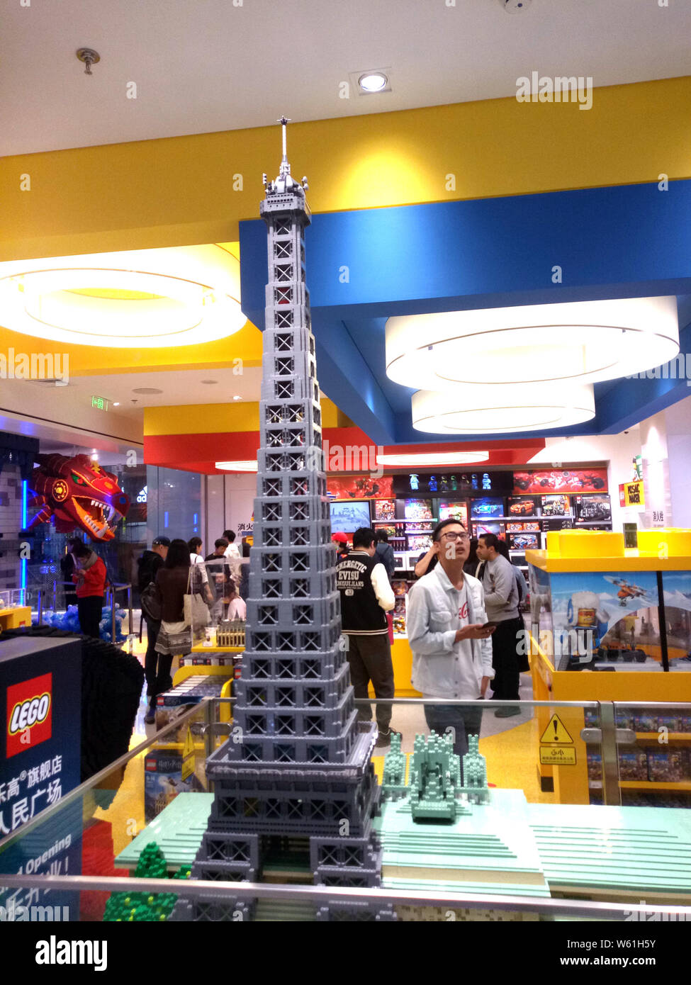 People visit the Lego Flagship store at Shanghai ShiMao Festival City ...