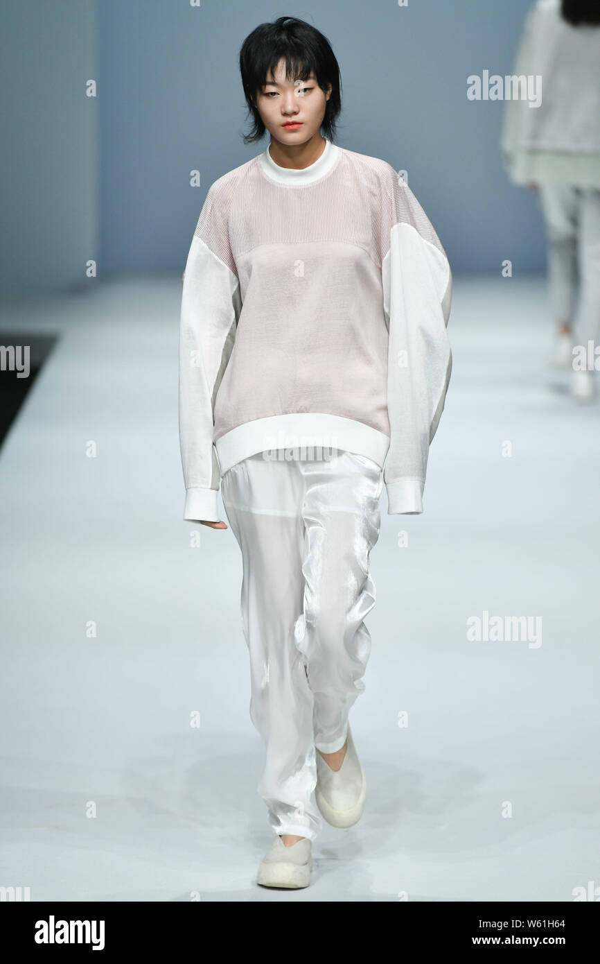 A model displays a new creation at the fashion show of SHANGSHOU & HELY ...