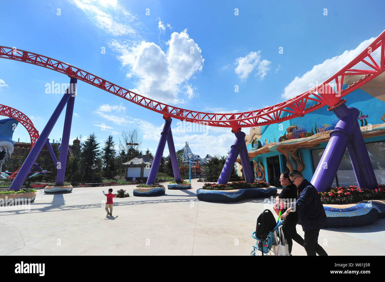 Tourists visit the Haichang Ocean Park during its trial operation in ...
