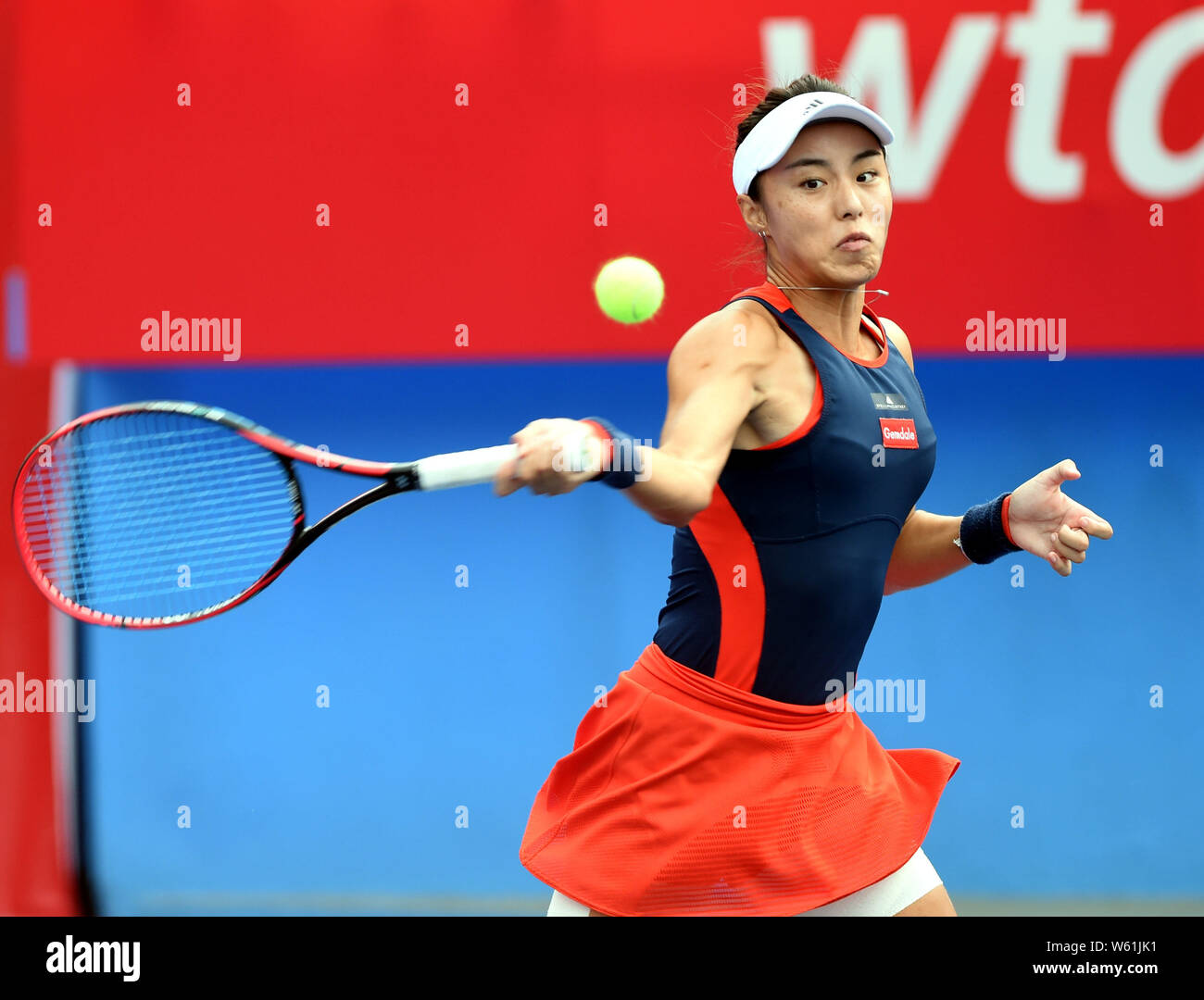 Wang Qiang of China returns a shot to Dayana Yastremska of Ukraine in ...