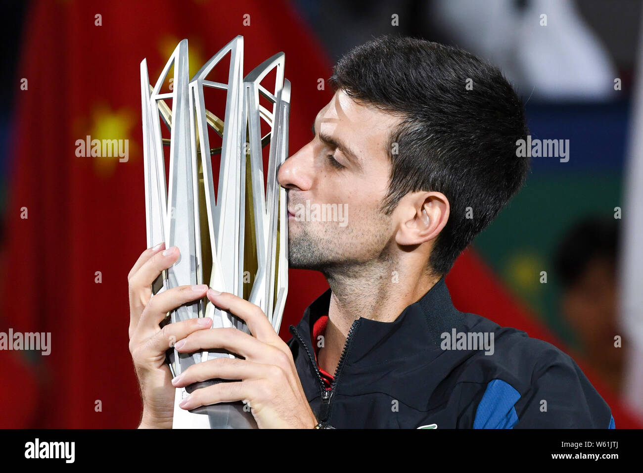 Novak Djokovic of Serbia kisses his champion trophy after defeating ...