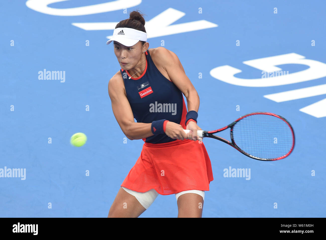 Wang Qiang of China returns a shot to Dayana Yastremska of Ukraine in ...