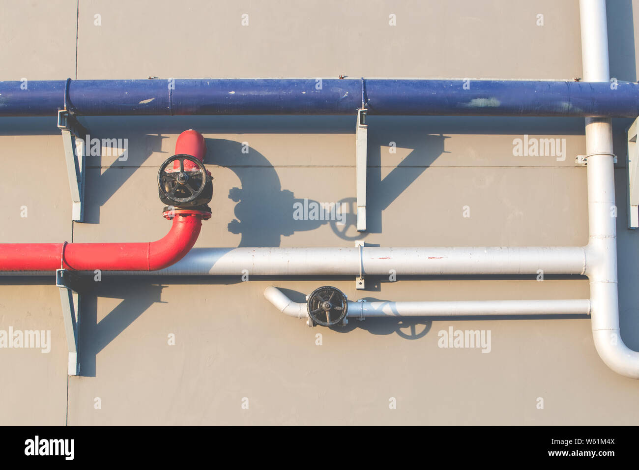 water pipes on building wall Stock Photo - Alamy