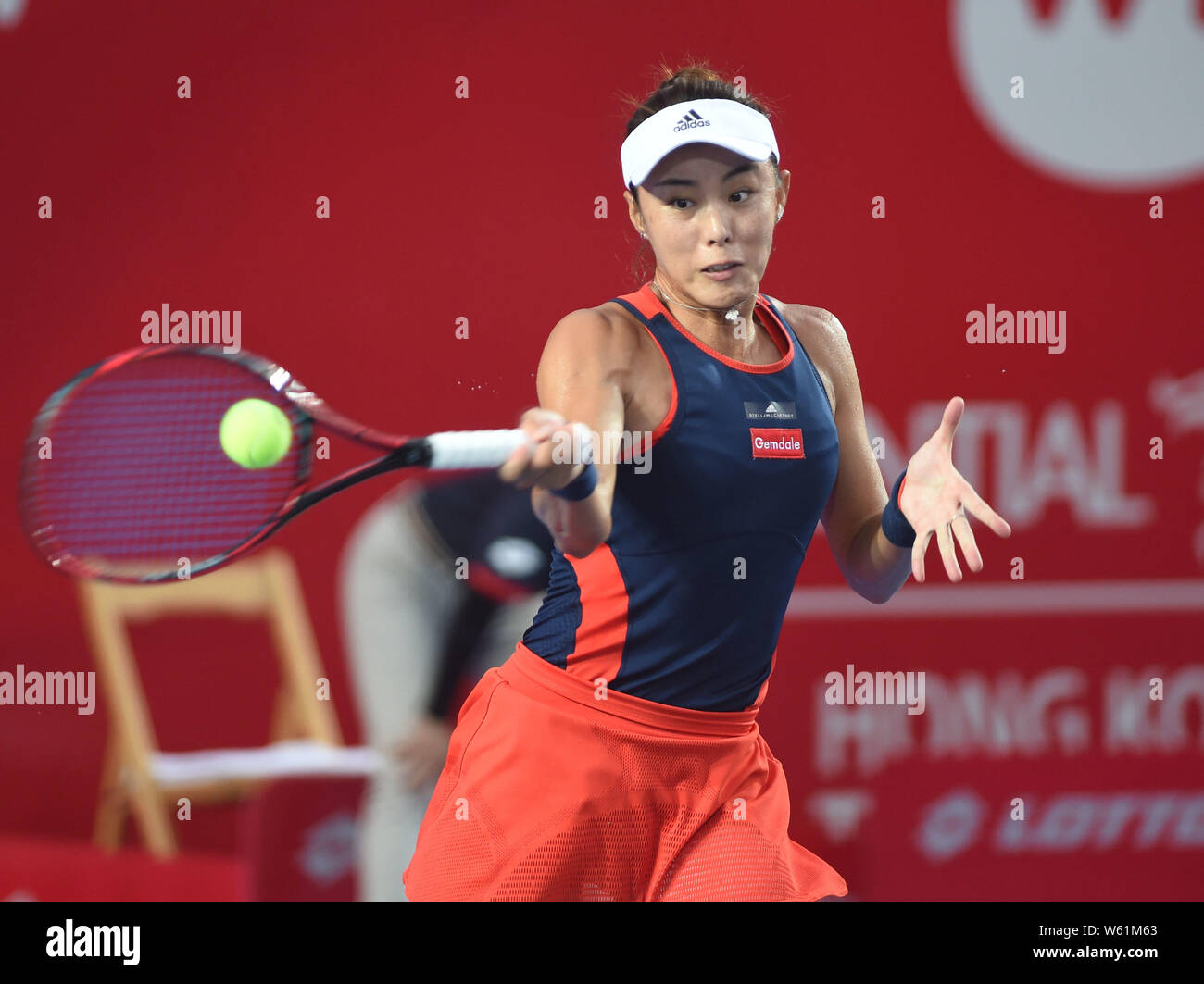Wang Qiang of China returns a shot to Zhang Ling of Chinese Hong Kong ...