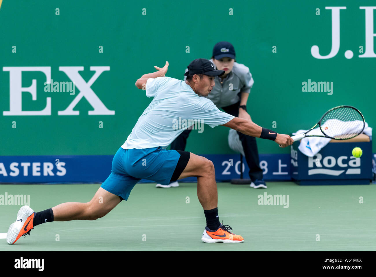 Zhang Ze of China returns a shot to Daniil Medvedev of Russia in their ...