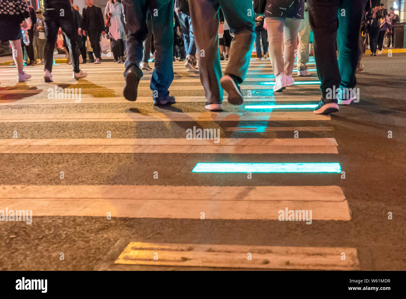 Pedestrians walk on China's first sidewalk-embedded pedestrian lights ...