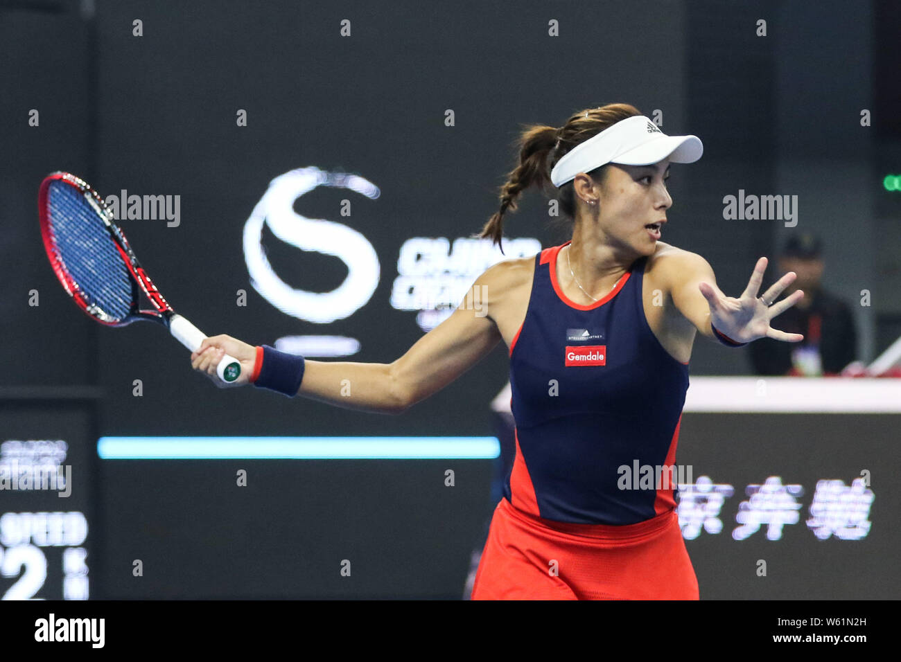 Wang Qiang of China returns a shot against Aryna Sabalenka of Belarus ...