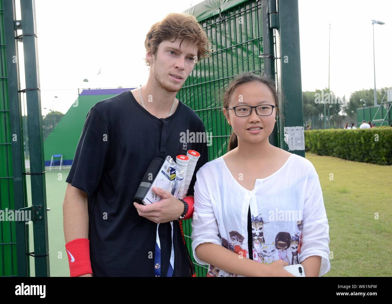 Russian tennis player Andrey Rublev poses with a fan for a photo after ...