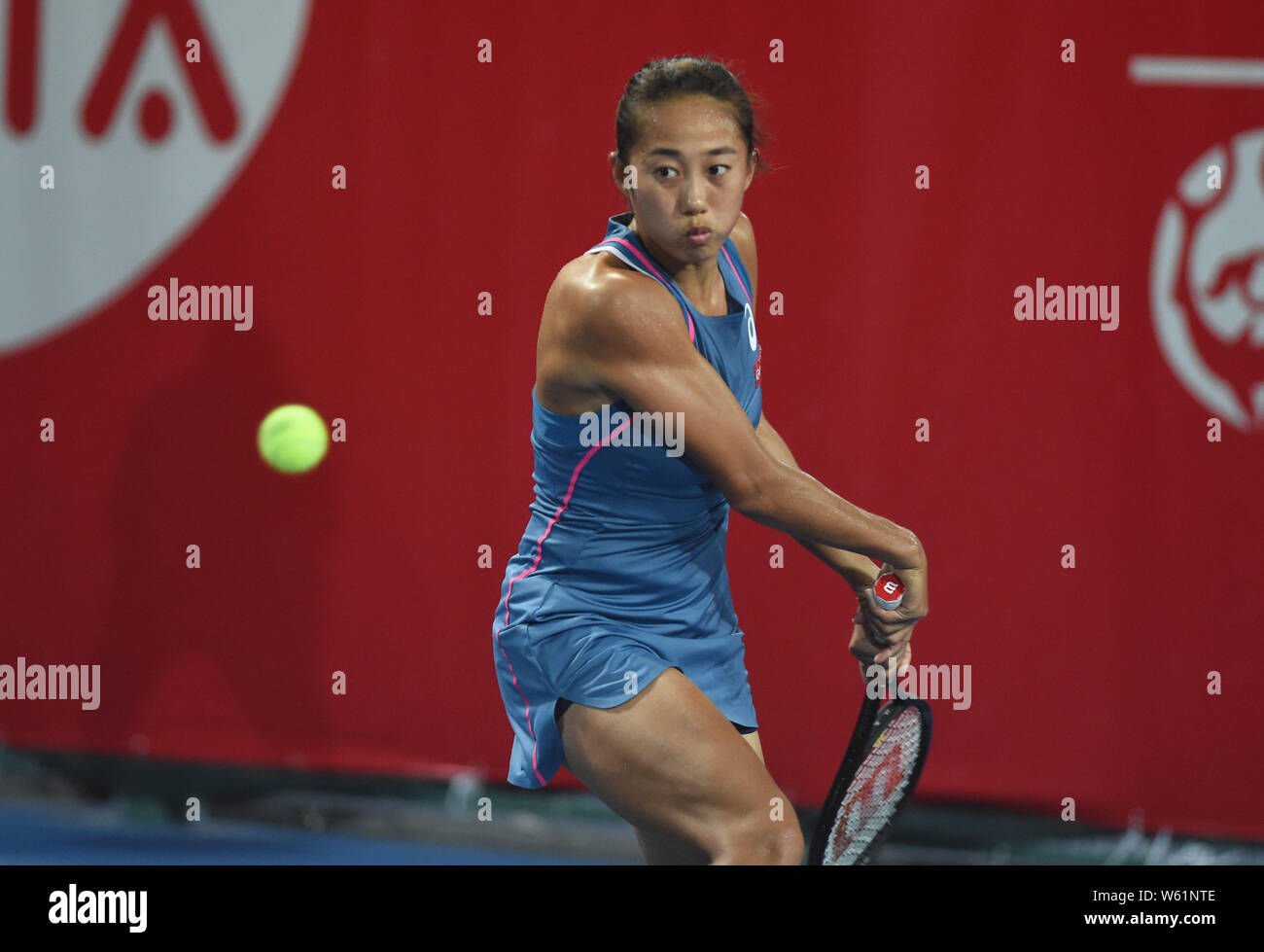 Zhang Shuai of China returns a shot to Sabina Sharipova of Uzbekistan ...
