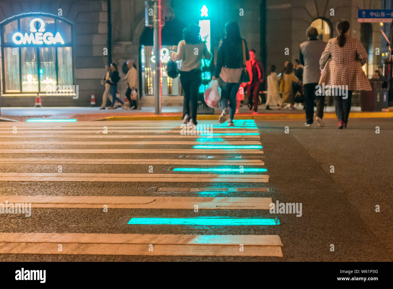 Pedestrians walk on China's first sidewalk-embedded pedestrian lights ...