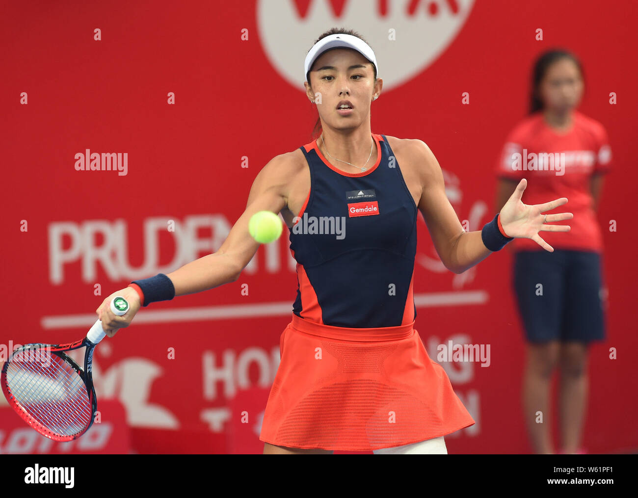 Wang Qiang of China returns a shot to Zhang Ling of Chinese Hong Kong ...