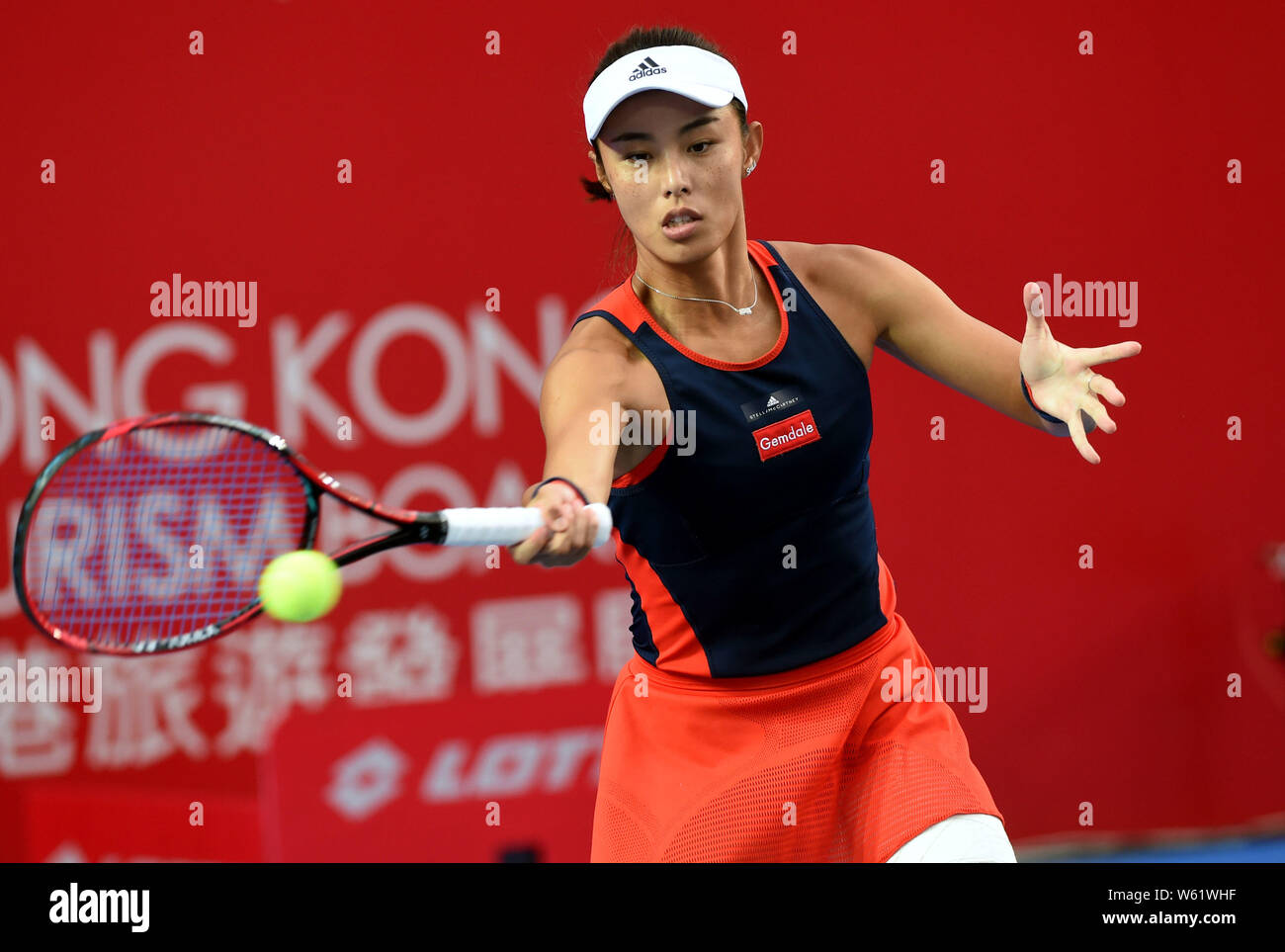Wang Qiang of China returns a shot to Zhang Ling of Chinese Hong Kong ...