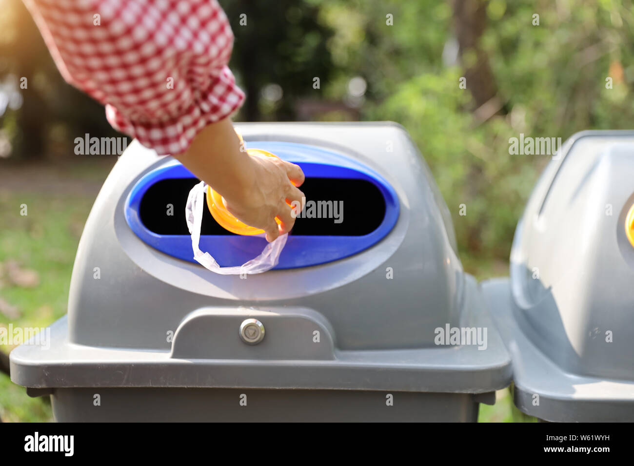 woman hands throw empty plastic tumbler into the garbage Stock Photo ...
