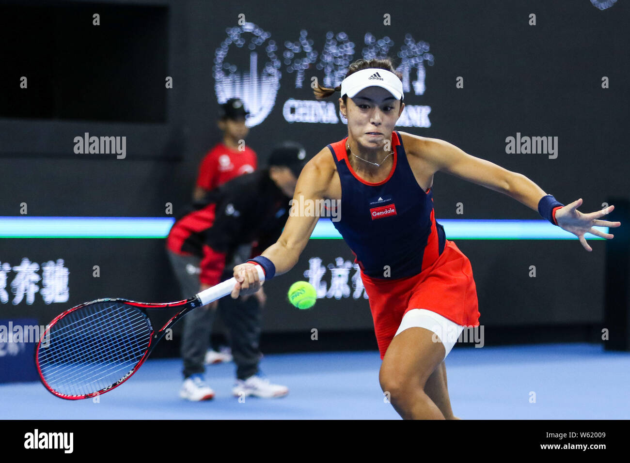 Wang Qiang of China returns a shot to Caroline Wozniacki of Denmark in ...