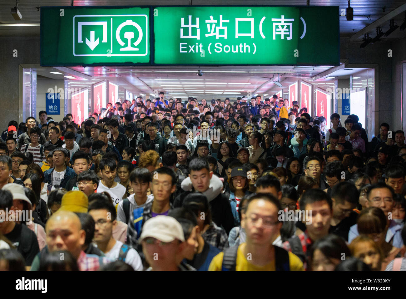 Chinese tourists and passengers get off the trains during the week-long ...
