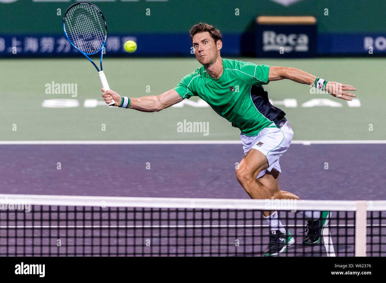 Matthew Ebden of Australia returns a shot to Dominic Thiem of Austria ...