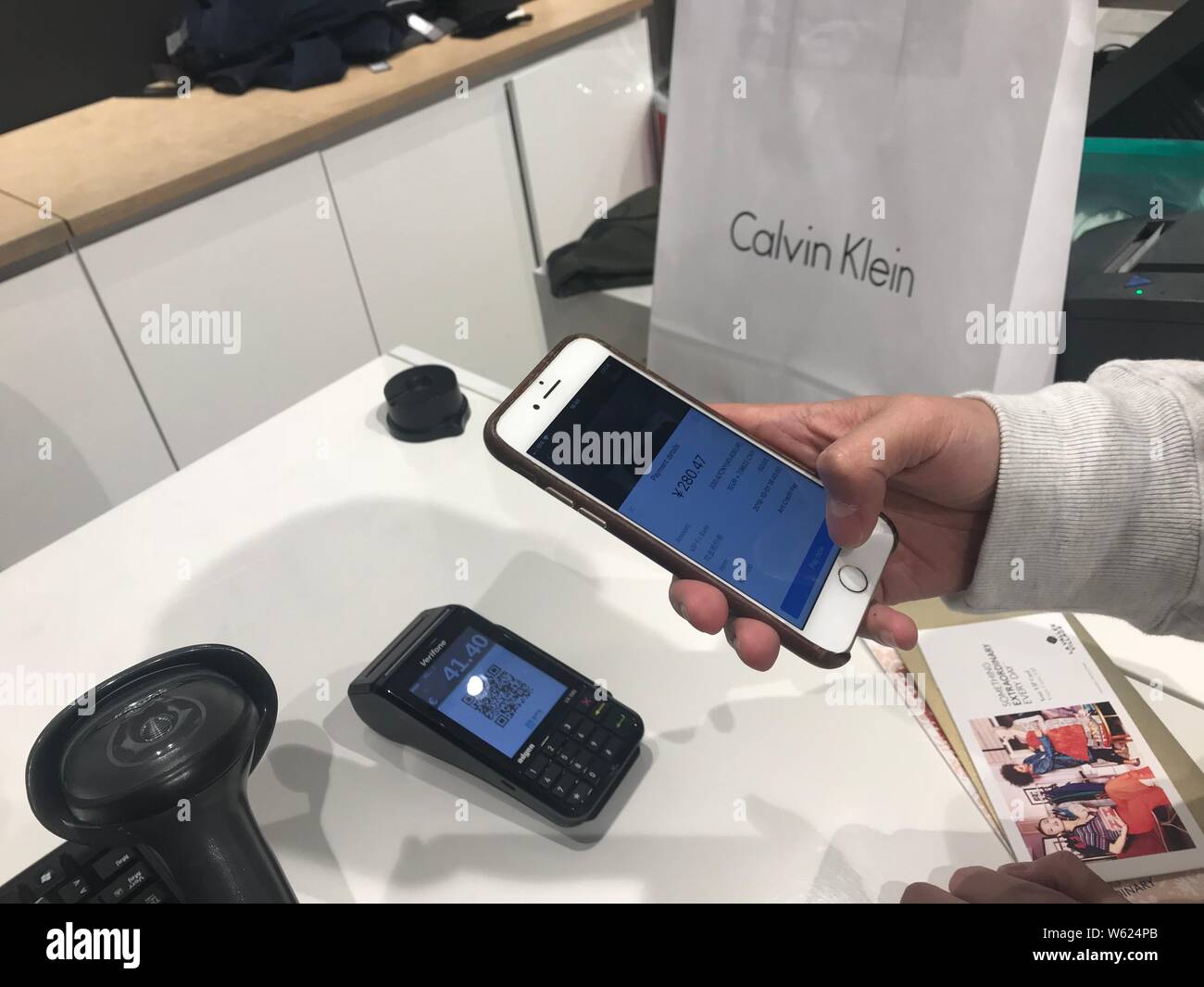 --FILE--A Chinese mobile phone user scans a QR code via mobile payment ...