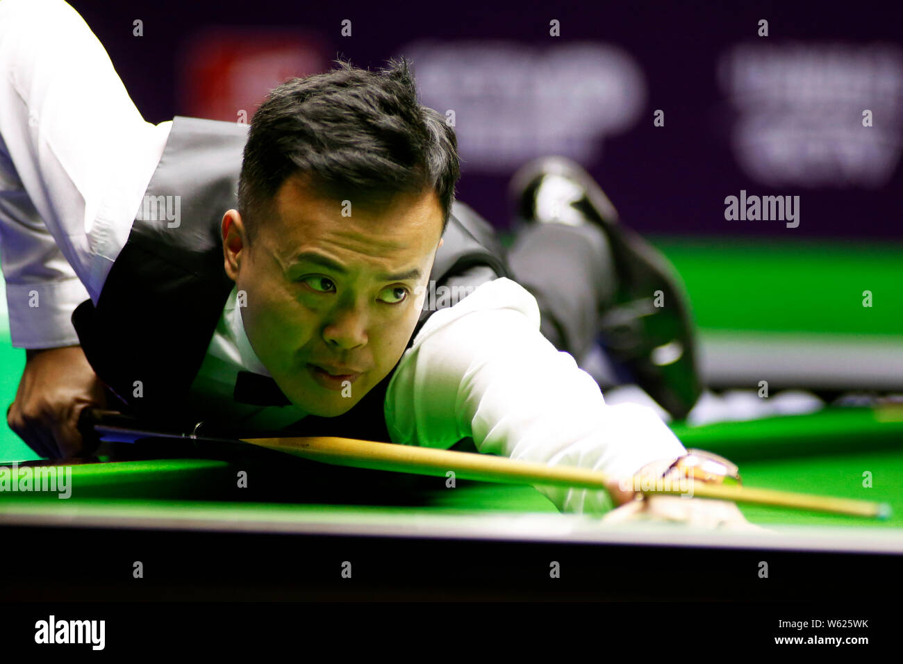 Marco Fu of Chinese Hong Kong plays a shot to Jack Lisowski of England ...