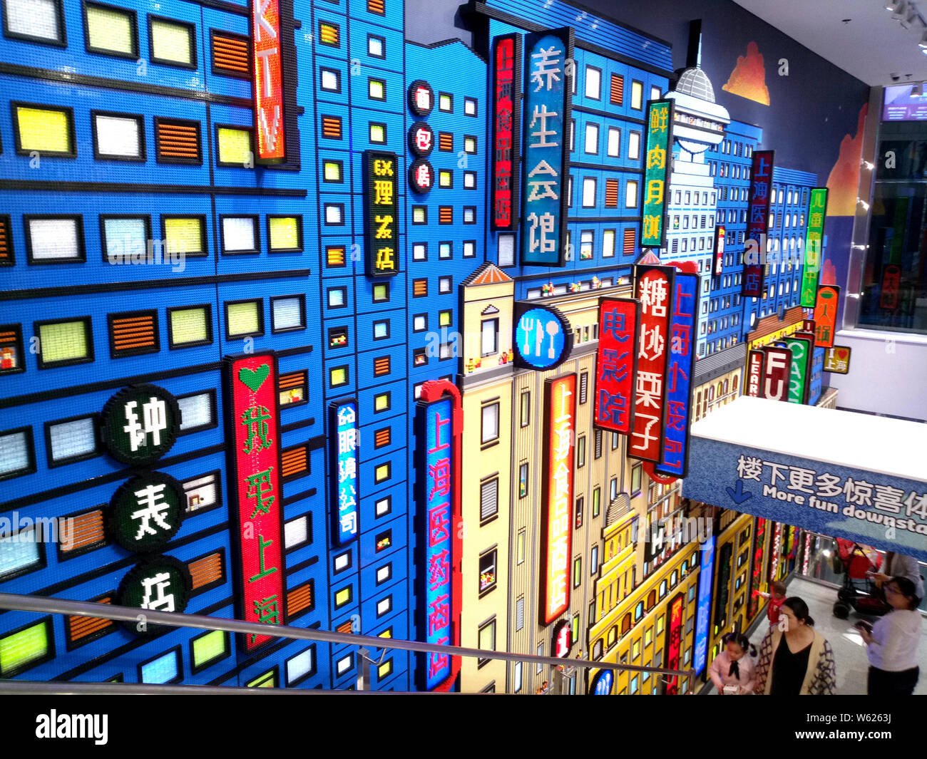 People visit the Lego Flagship store at Shanghai ShiMao Festival City ...