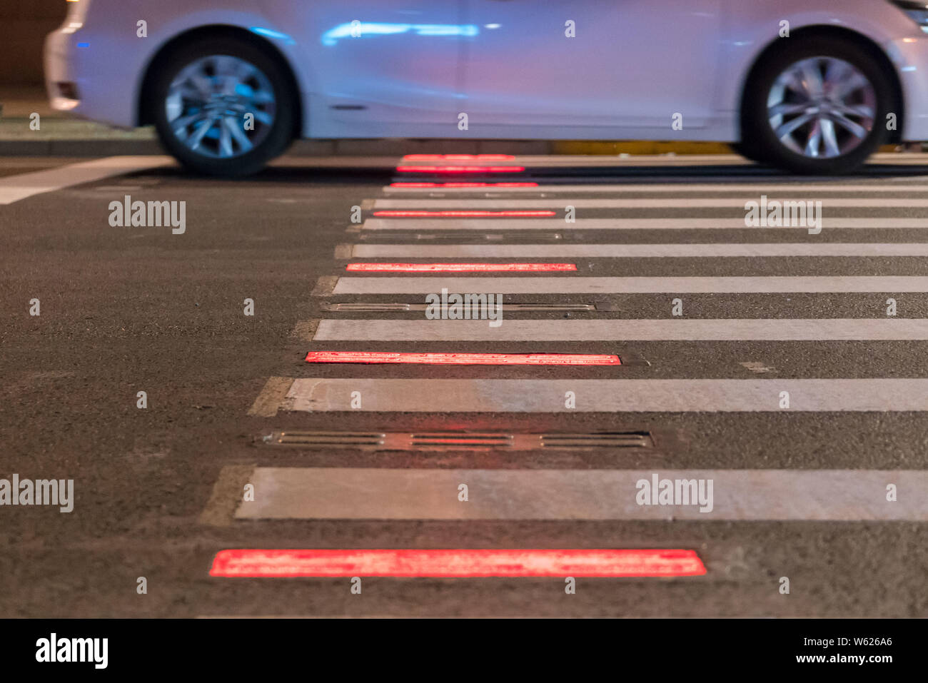 A car drives through China's first sidewalk-embedded pedestrian lights ...