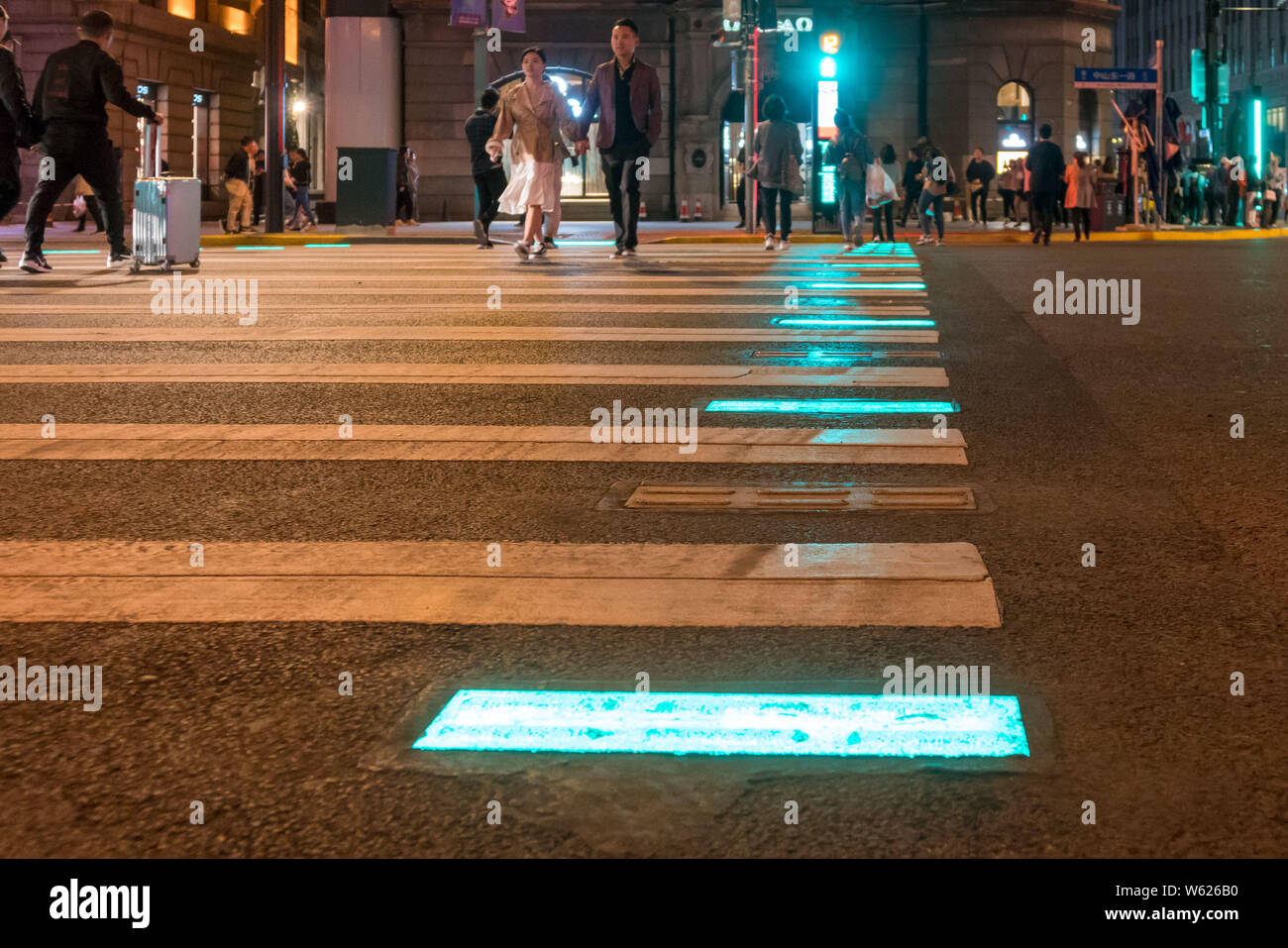 Pedestrians walk on China's first sidewalk-embedded pedestrian lights ...
