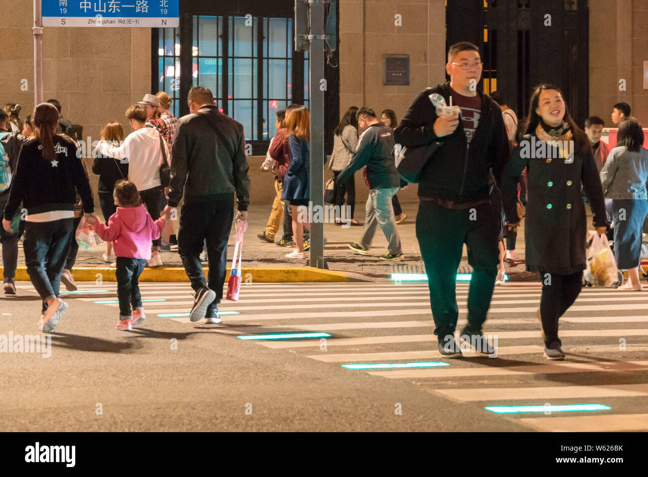 Pedestrians walk on China's first sidewalk-embedded pedestrian lights ...