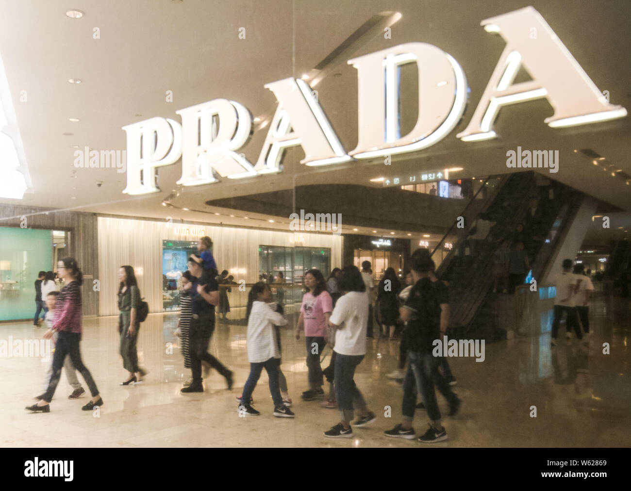 --FILE--Customers walk past a boutique of Prada at a shopping mall in ...