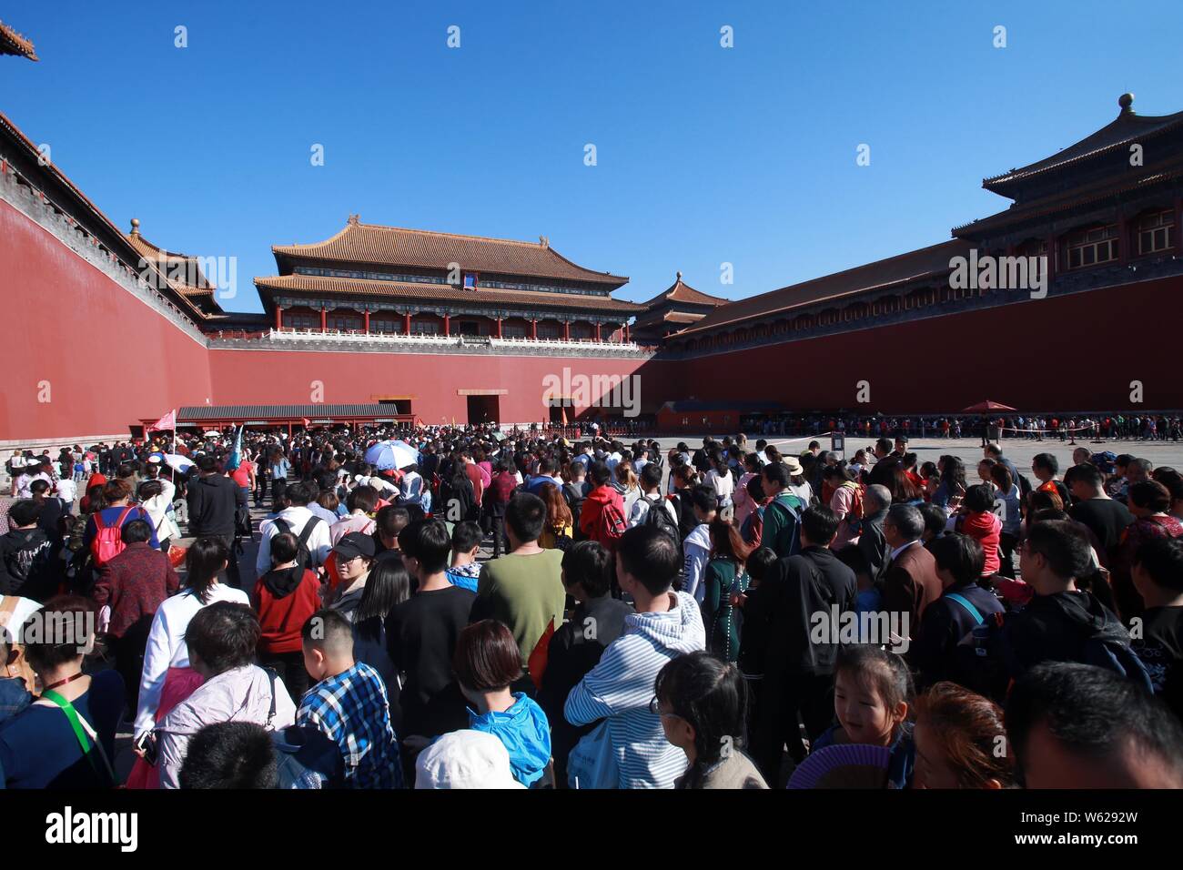 Crowds of Chinese tourists queue up to visit the Palace Museum, also ...