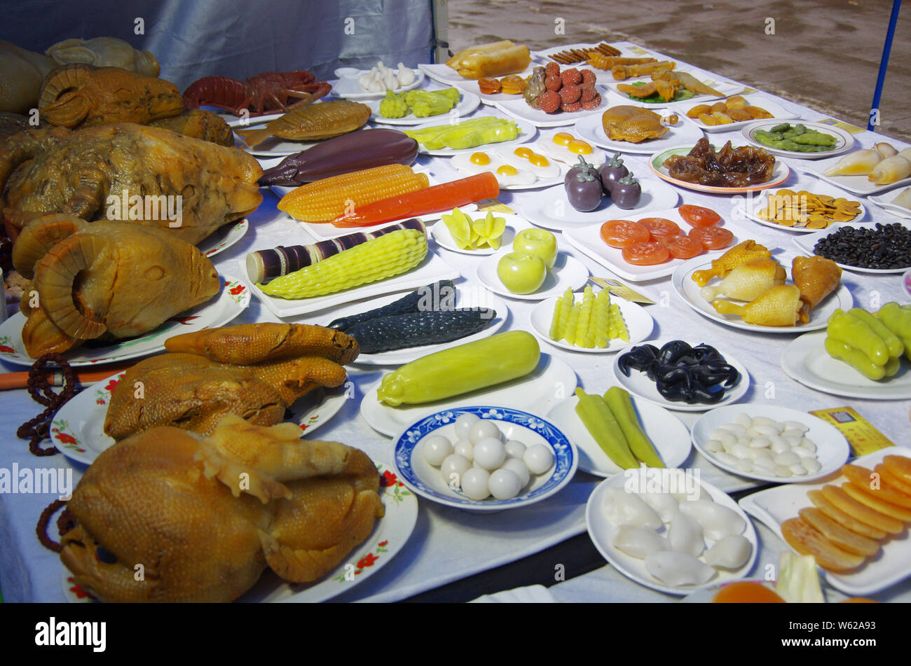 Various rare stones in the shape of Chinese dishes are on display at ...