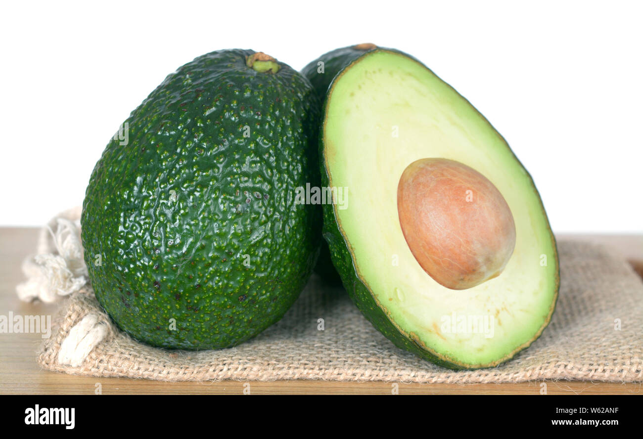 fresh full and section avocado showing at market place Stock Photo - Alamy
