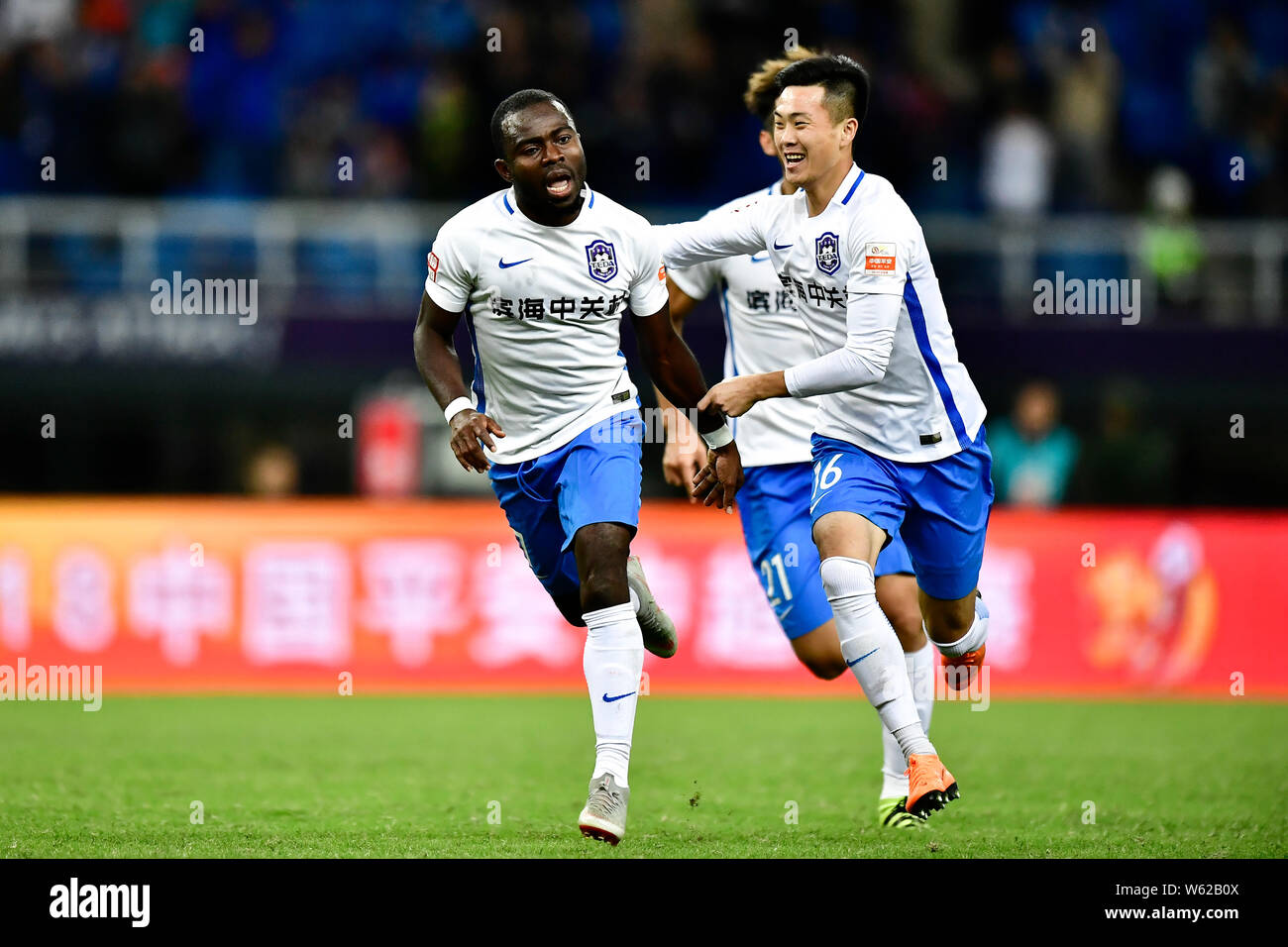 Ghanaian football player Frank Acheampong, left, of Tianjin TEDA ...