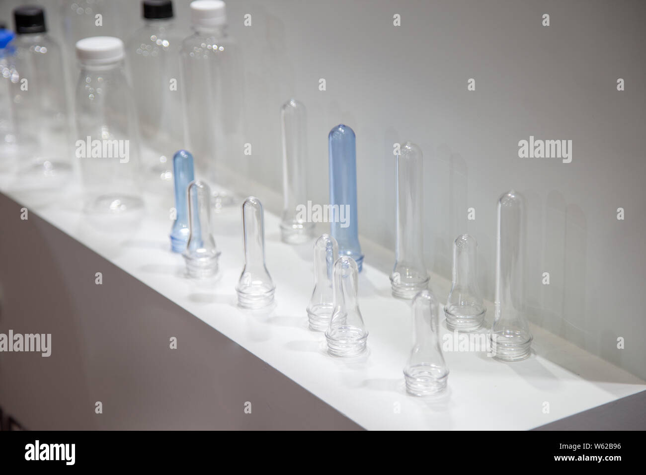 Raw material for plastic bottle blowing machine Stock Photo - Alamy