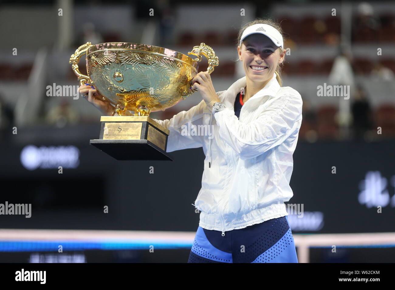 Caroline Wozniacki of Denmark poses with her champion trophy after ...